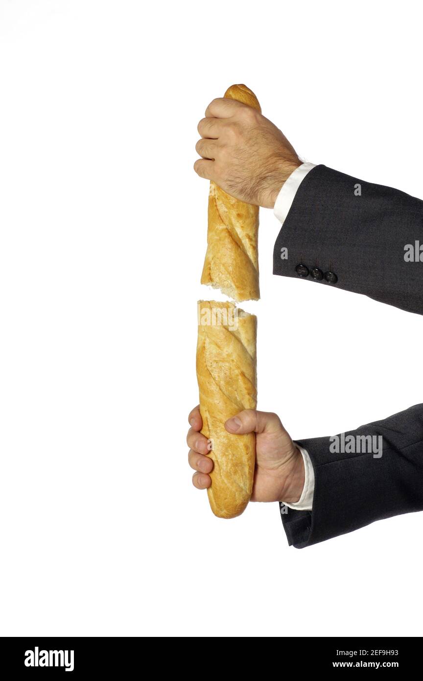 Man breaking a loaf of bread Cut Out Stock Images & Pictures - Alamy