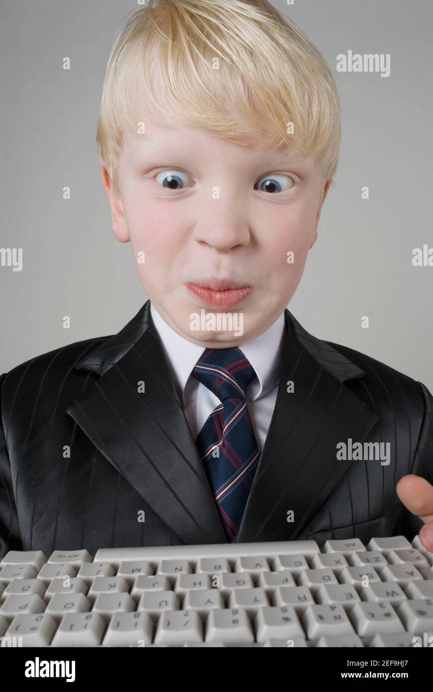 Close up of a boy holding a computer keyboard Stock Photo - Alamy