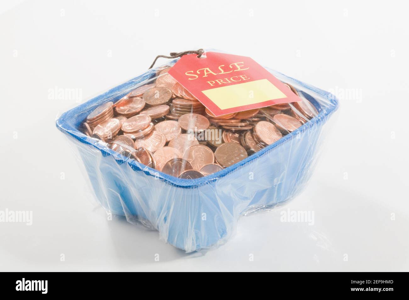 Coins in a basket with a price tag Stock Photo - Alamy