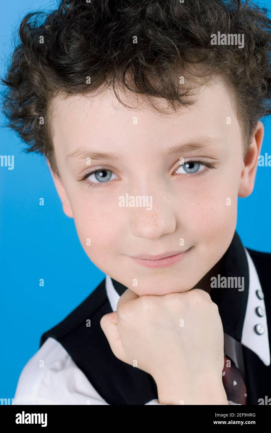 Portrait of a boy with his hand on his chin Stock Photo - Alamy