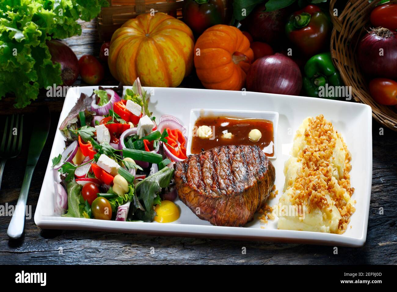 Filet mignon with vegetables and mashed potato salad Stock Photo - Alamy