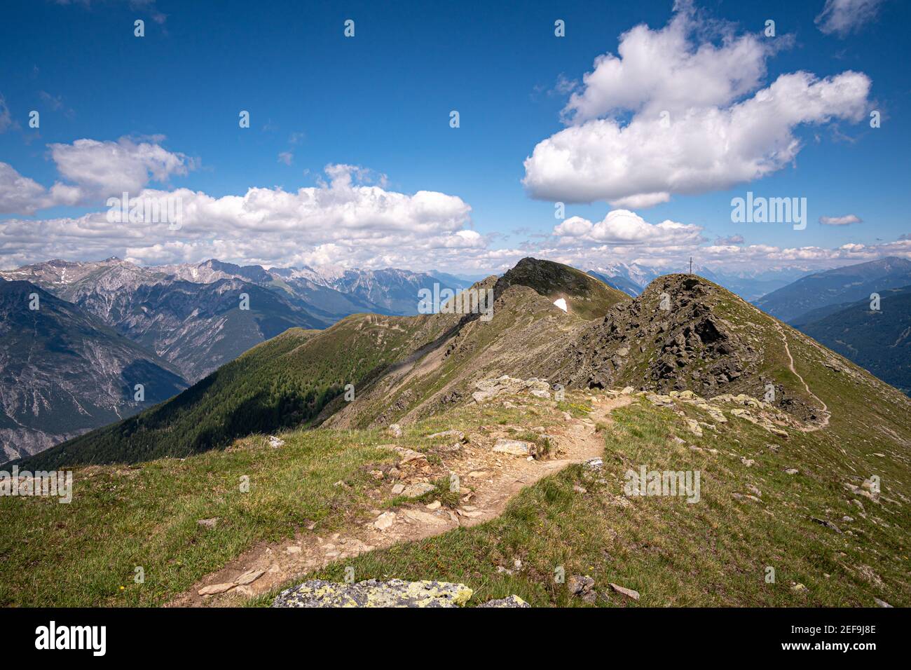Path to a summit cross on a mountain in the austrian alps Stock Photo ...