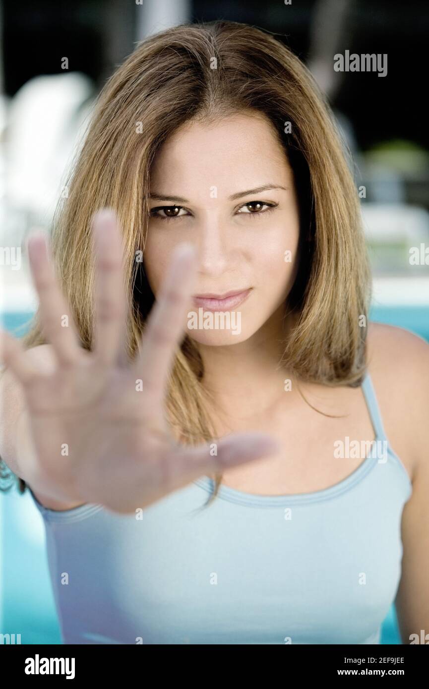 Portrait of a young woman making a stop sign Stock Photo - Alamy