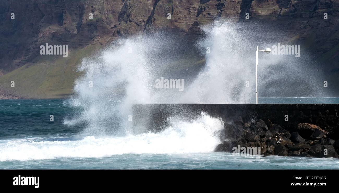 Lanzarote - Caleta de Famara, pier, strong wave Stock Photo - Alamy