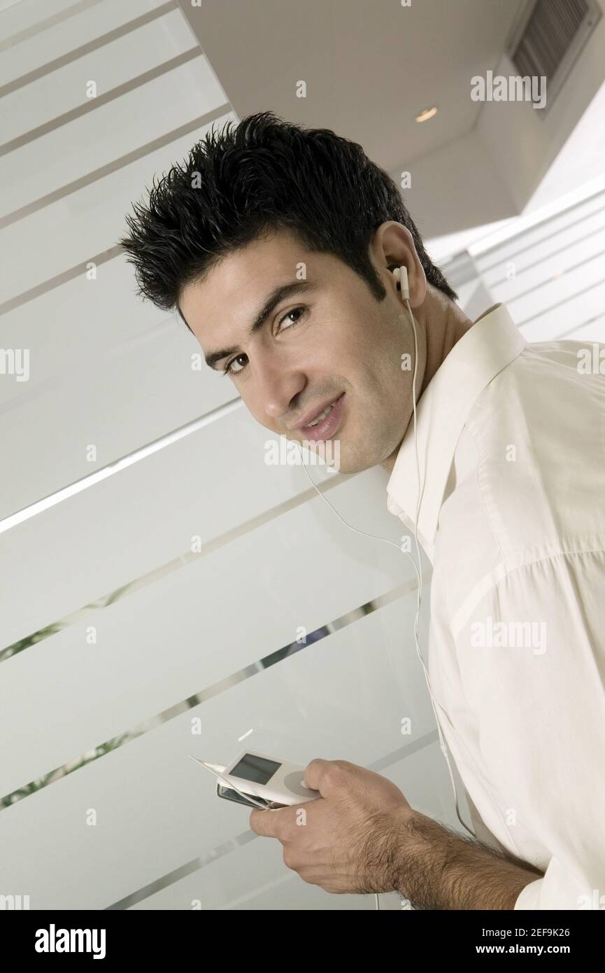 Side profile of a businessman listening to an MP3 Player Stock Photo ...