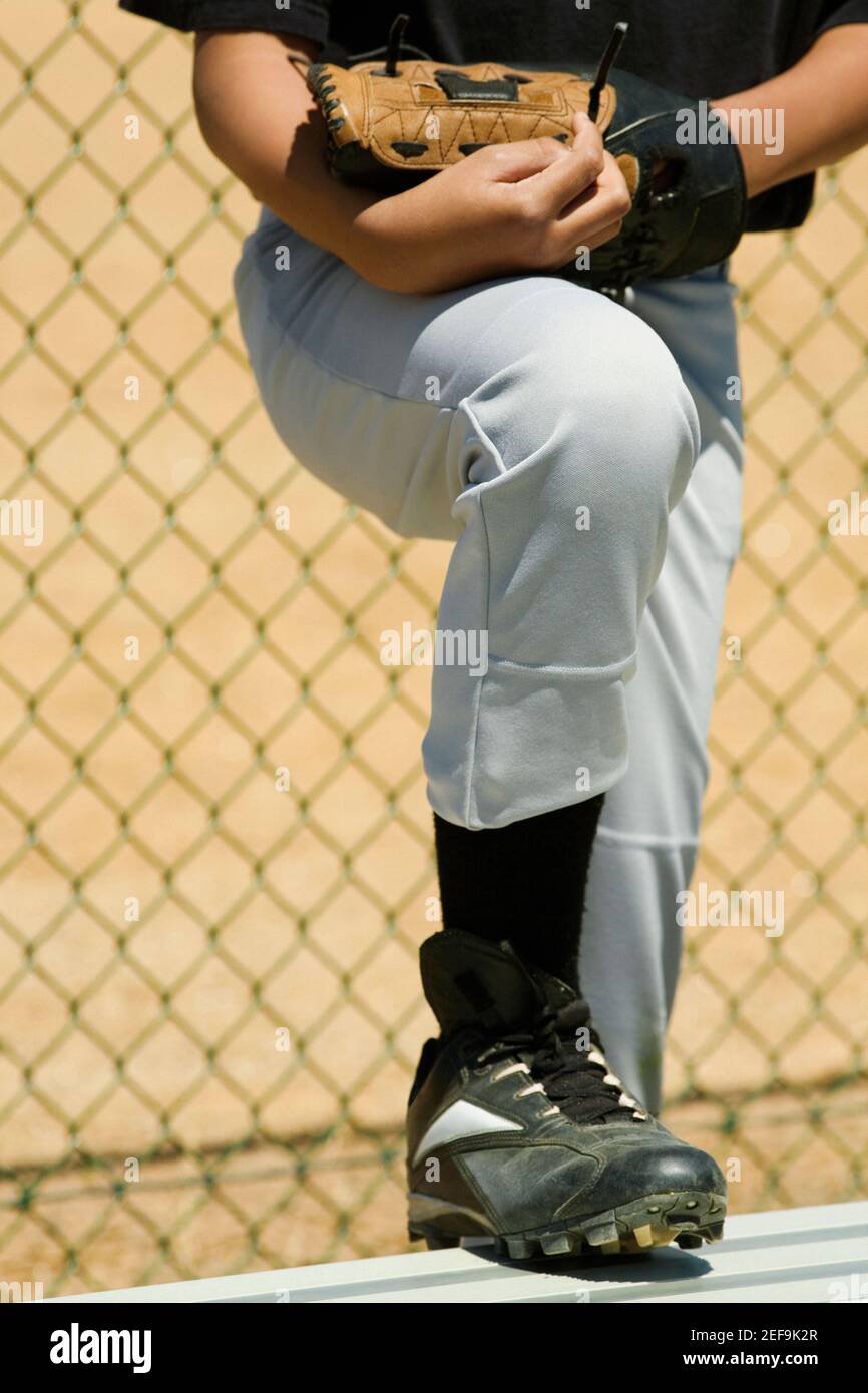 Low section view of a baseball player standing in a baseball field ...