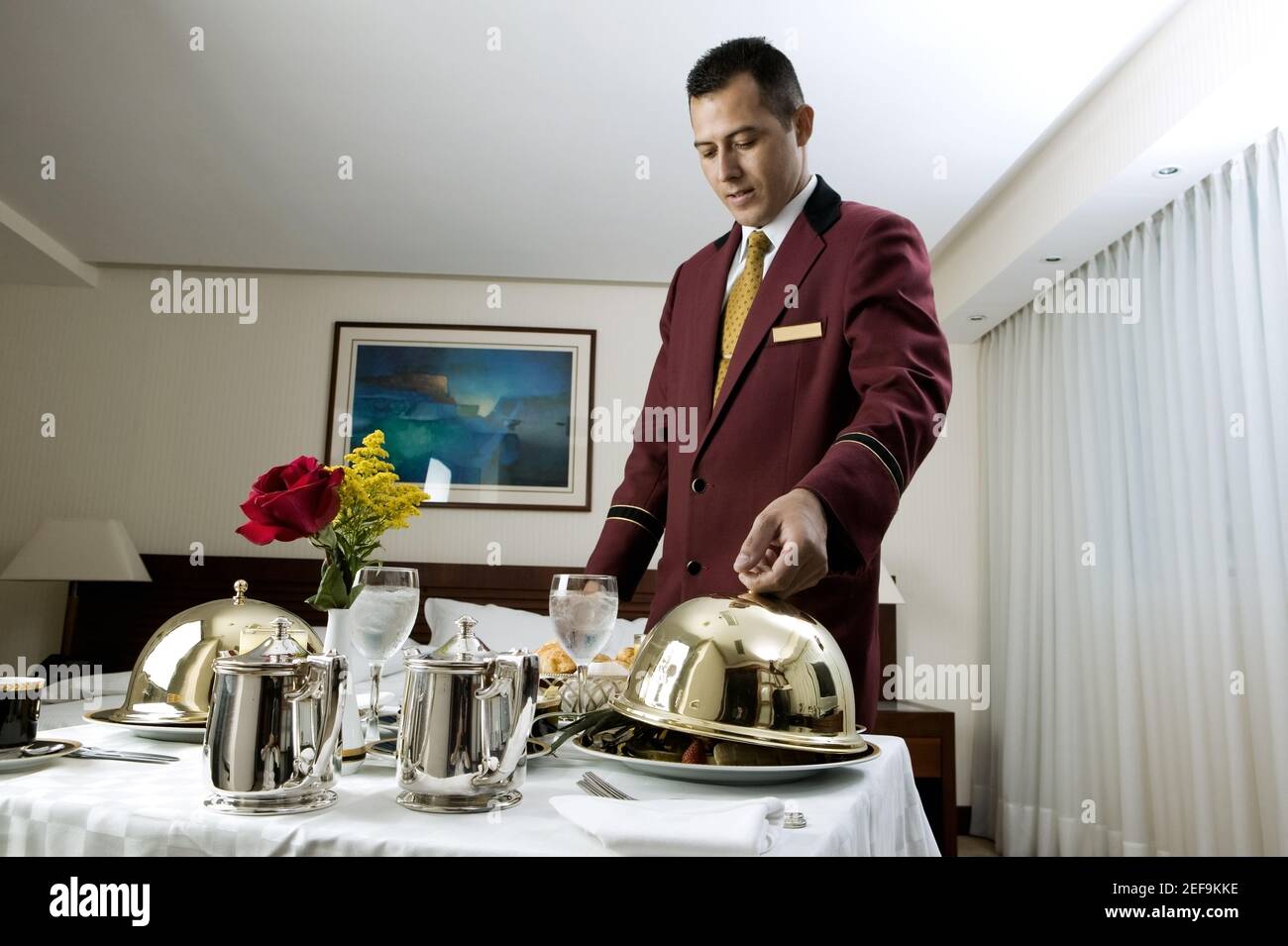 Waiter serving food Stock Photo - Alamy