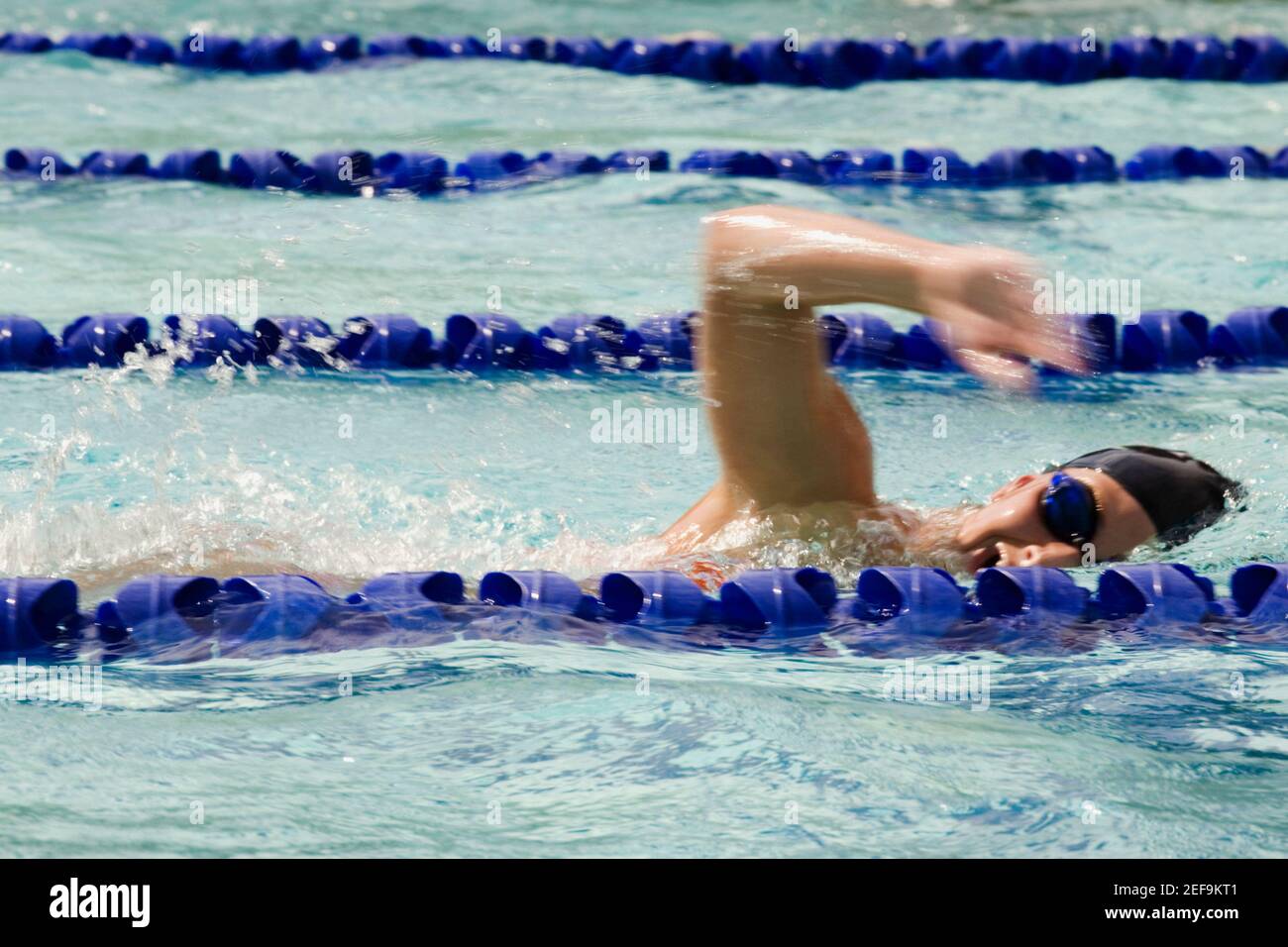 Side profile of a young man swimming in a swimming pool Stock Photo - Alamy