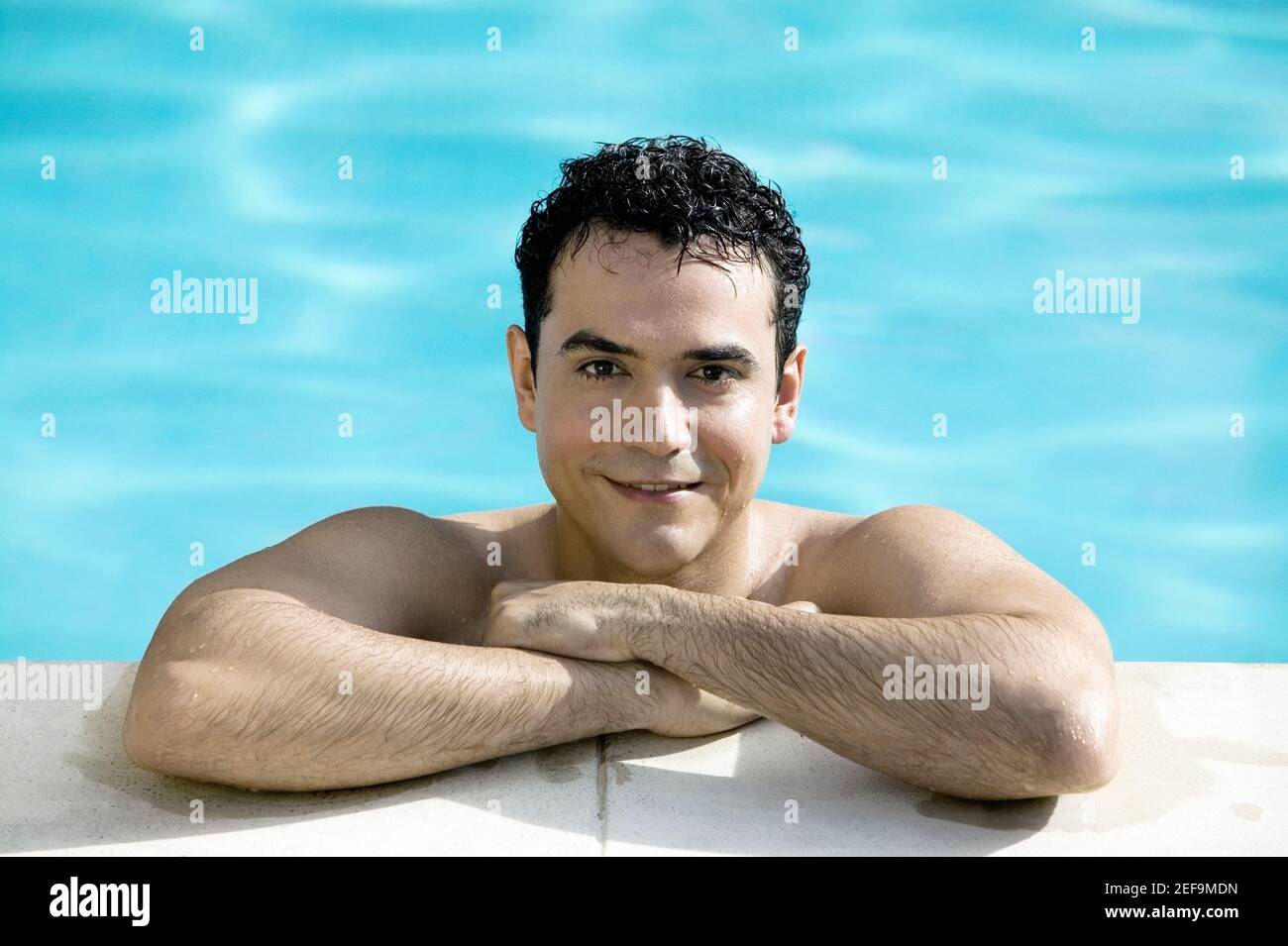 Portrait of a young man smiling in a swimming pool Stock Photo - Alamy