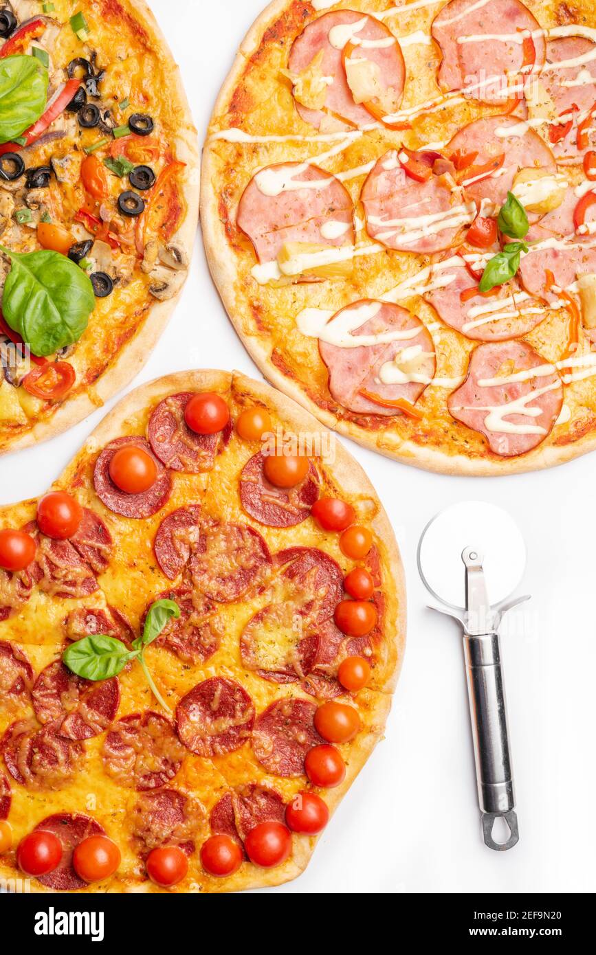 different various kind of pizzas in assortment with round knife Stock ...
