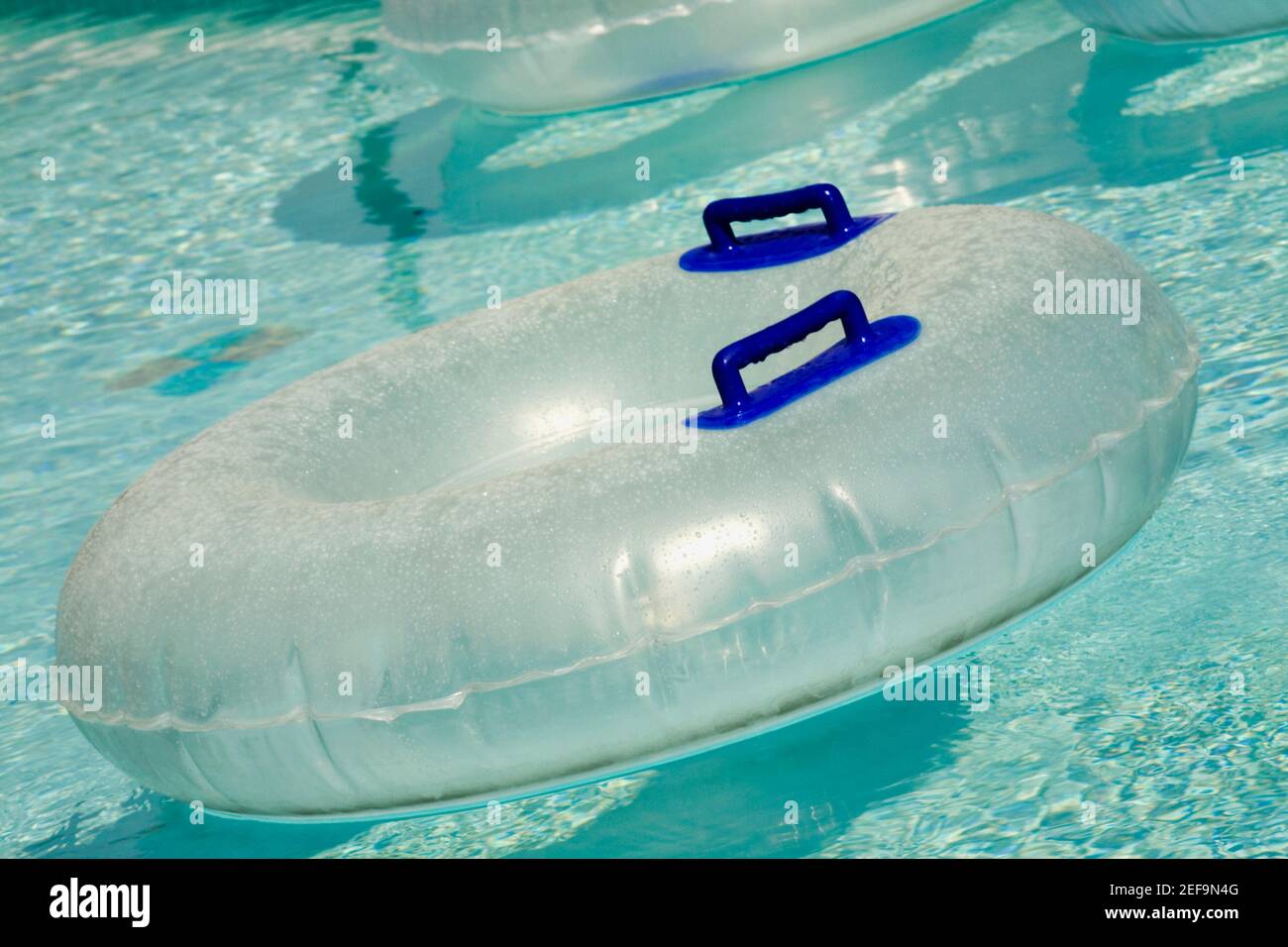 Inflatable rings floating in a pool Stock Photo - Alamy