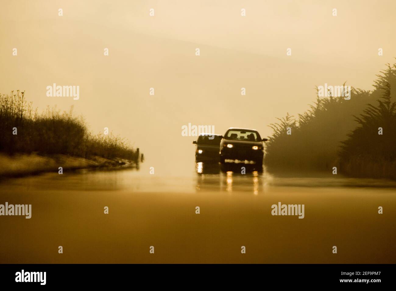 Two car moving on a road Stock Photo - Alamy