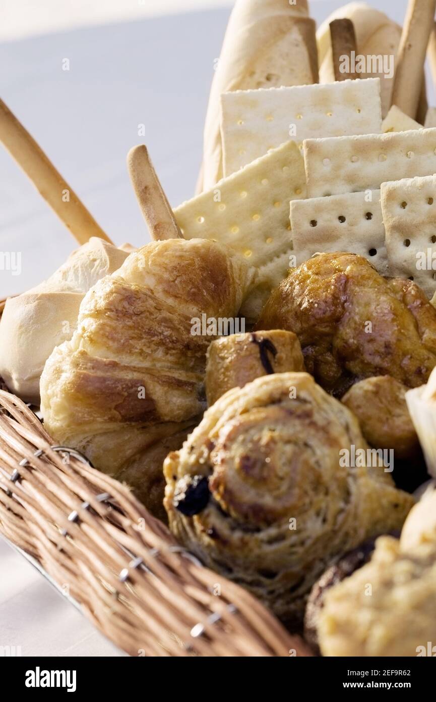 Close-up of croissant and crackers in a wicker basket Stock Photo - Alamy