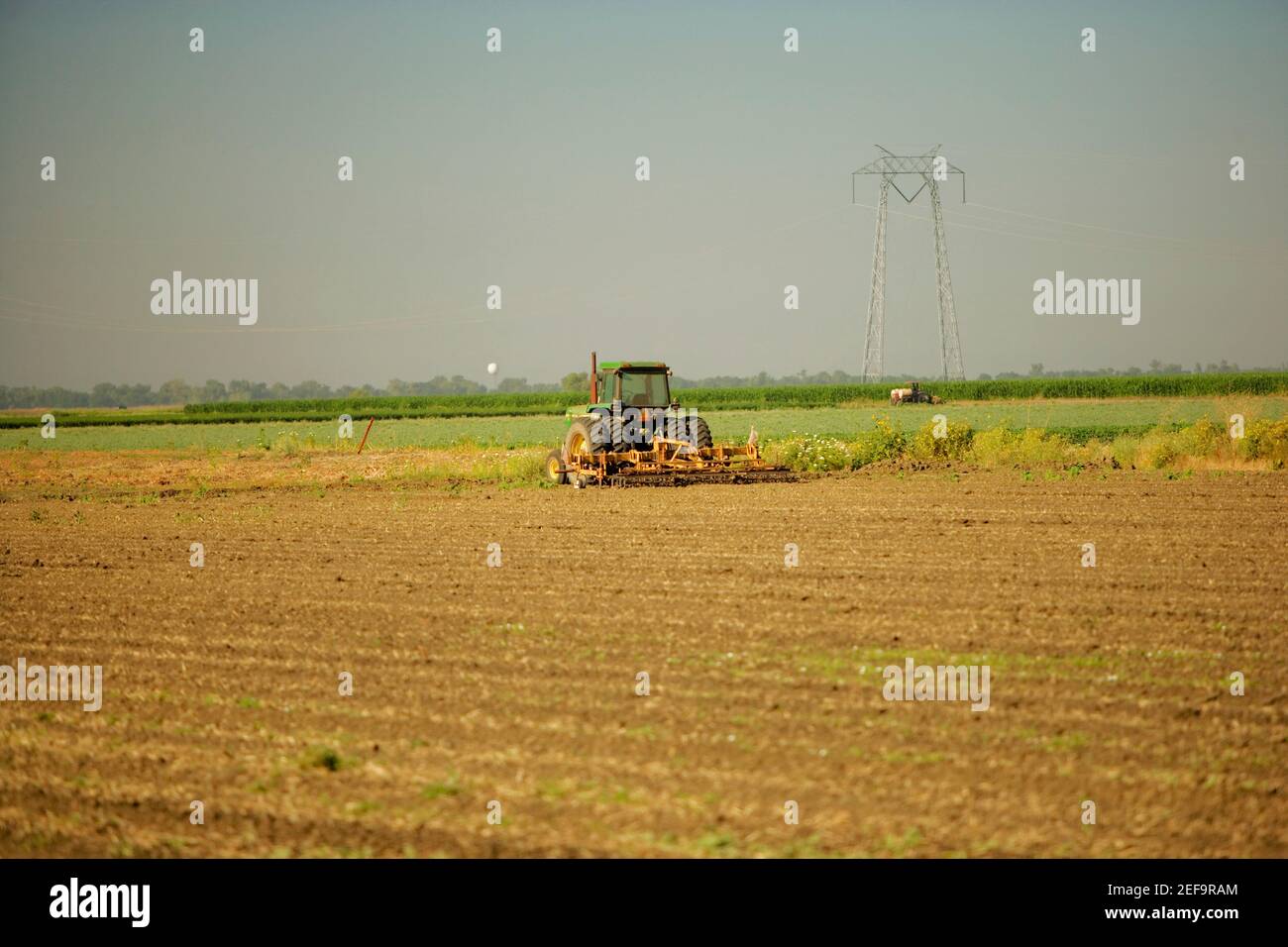 Tractor plowing a farm Stock Photo - Alamy