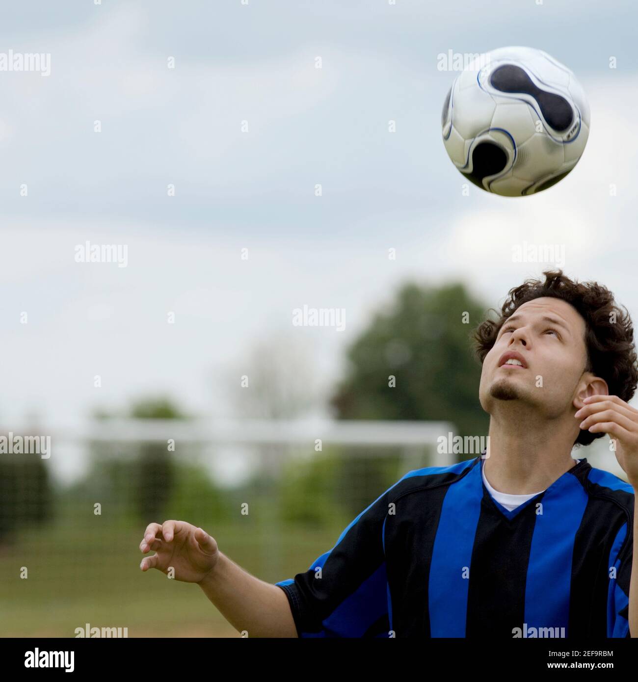 Close-up of a soccer player heading a soccer ball Stock Photo - Alamy