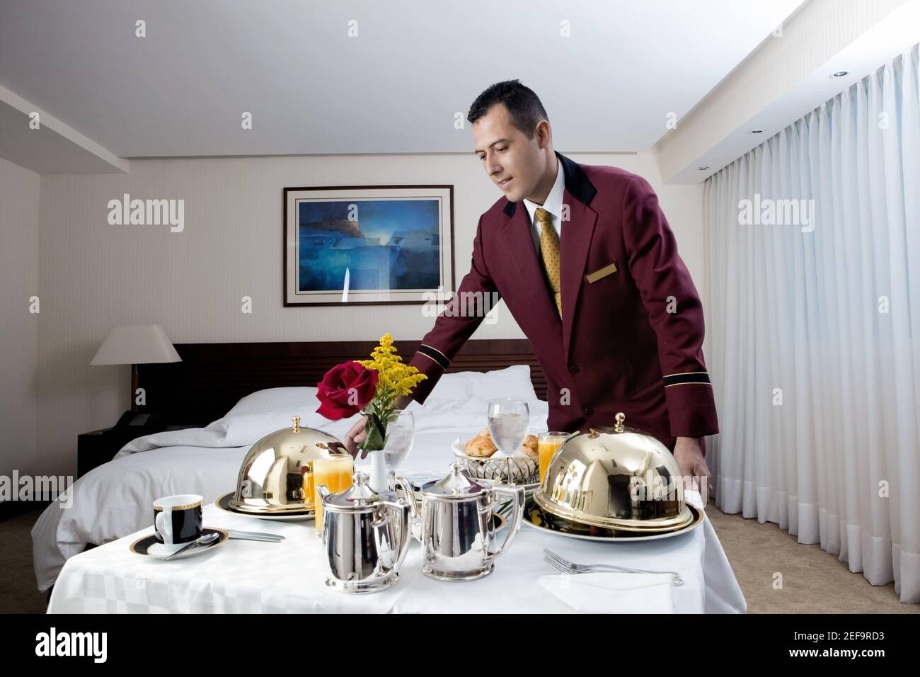 Waiter serving food Stock Photo - Alamy