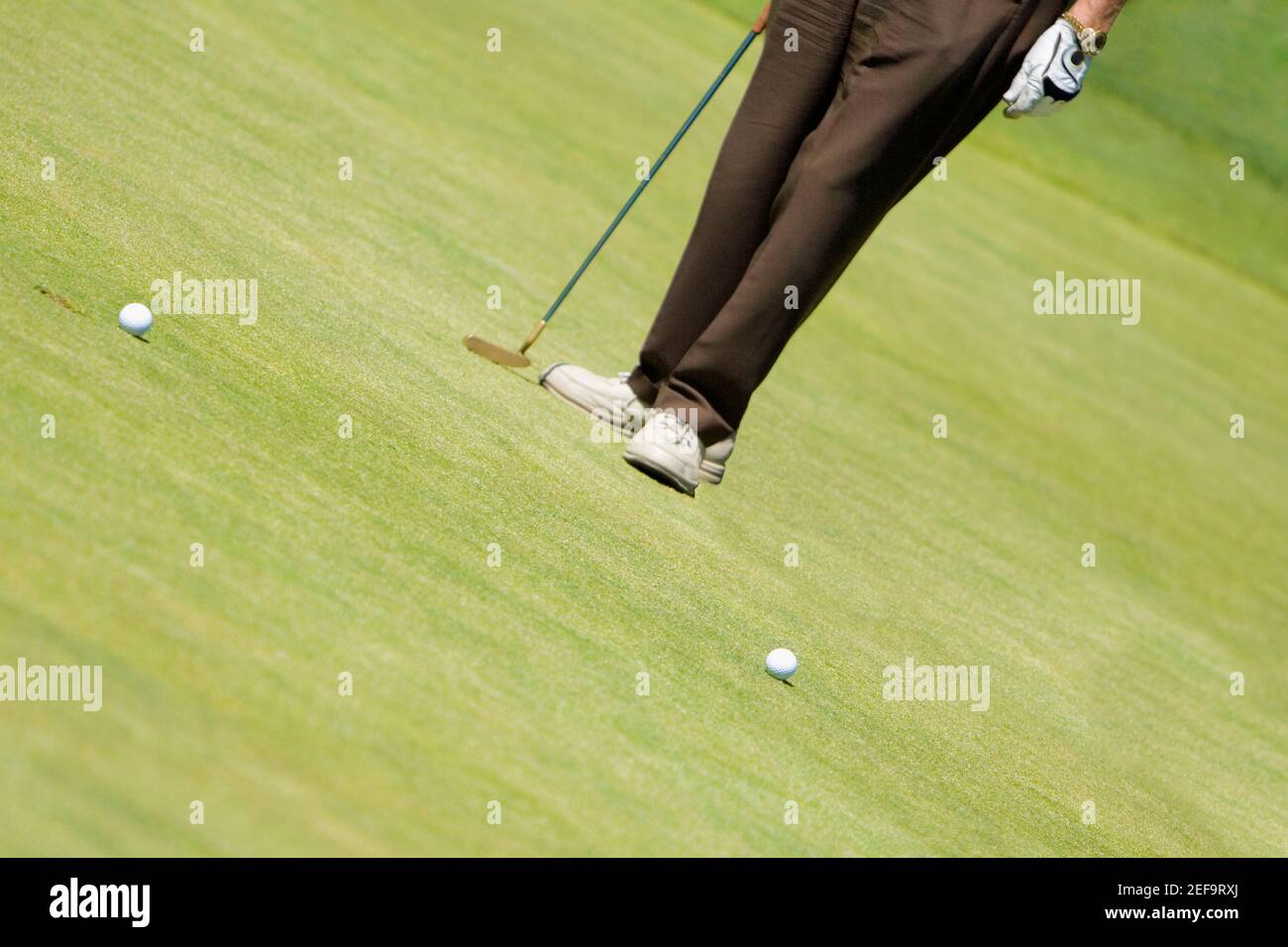 Low section view of a man holding a golf club on a golf course Stock ...
