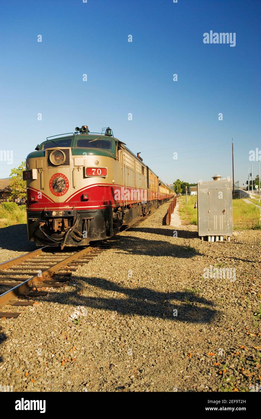 Commuter train moving on railroad track Stock Photo - Alamy