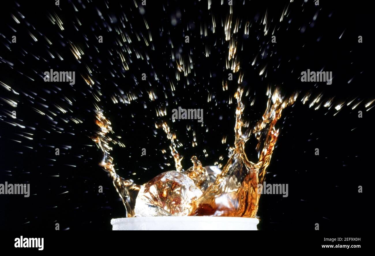 Close-up of water splashing out of a glass Stock Photo - Alamy