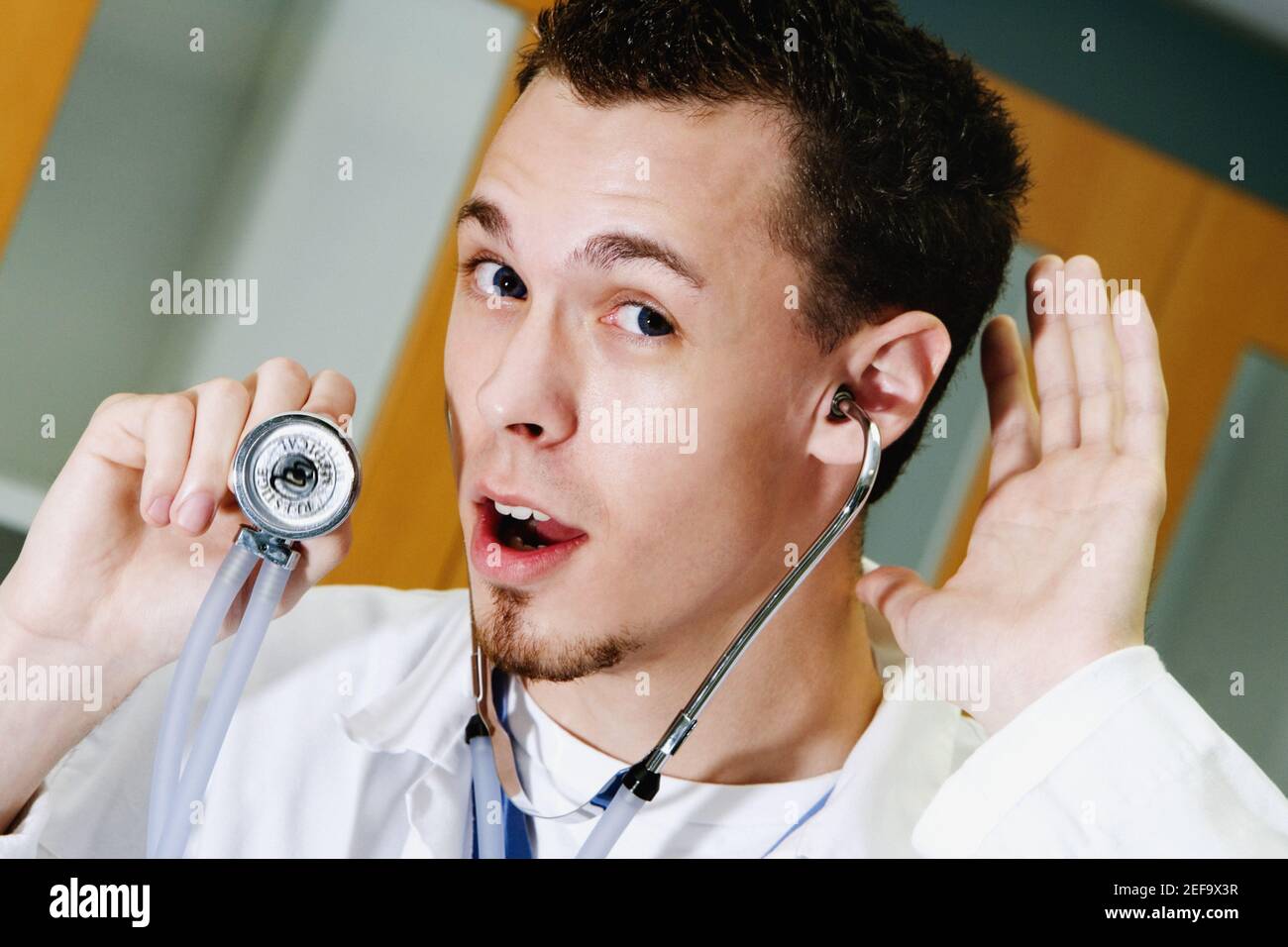 Close-up of a male doctor listening with a stethoscope Stock Photo - Alamy