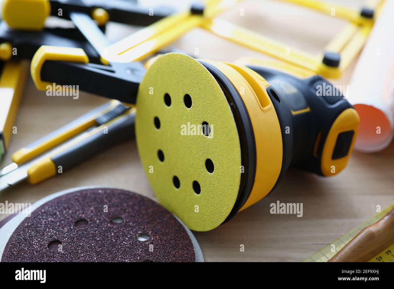 Yellow disc sander is on table closeup Stock Photo - Alamy