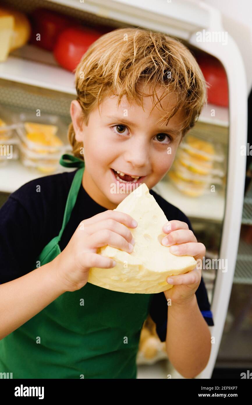 Portrait of a boy eating cheese Stock Photo - Alamy