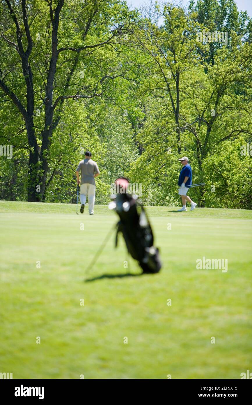 Two men walking on a golf course Stock Photo - Alamy