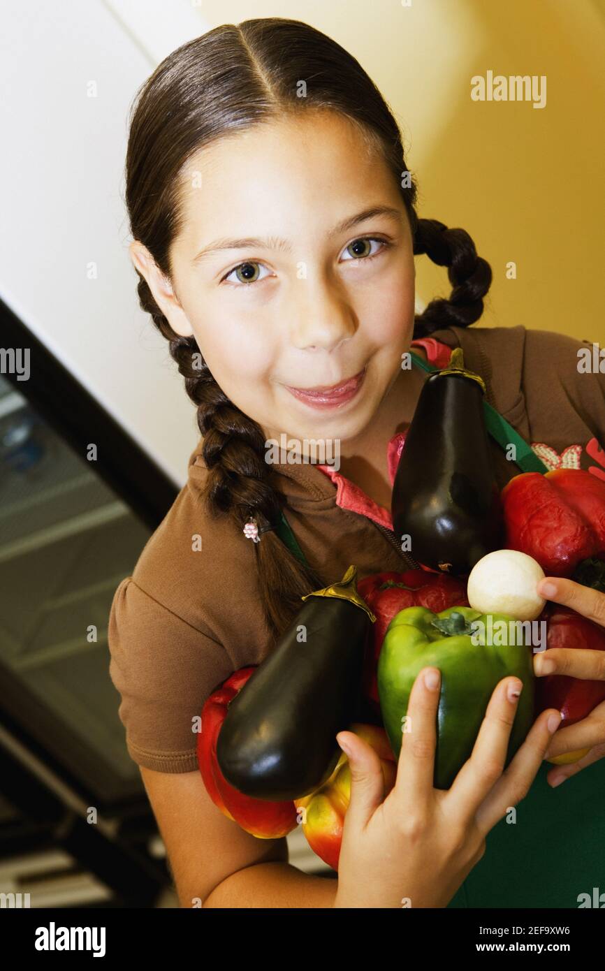 Portrait of a girl holding vegetables Stock Photo - Alamy
