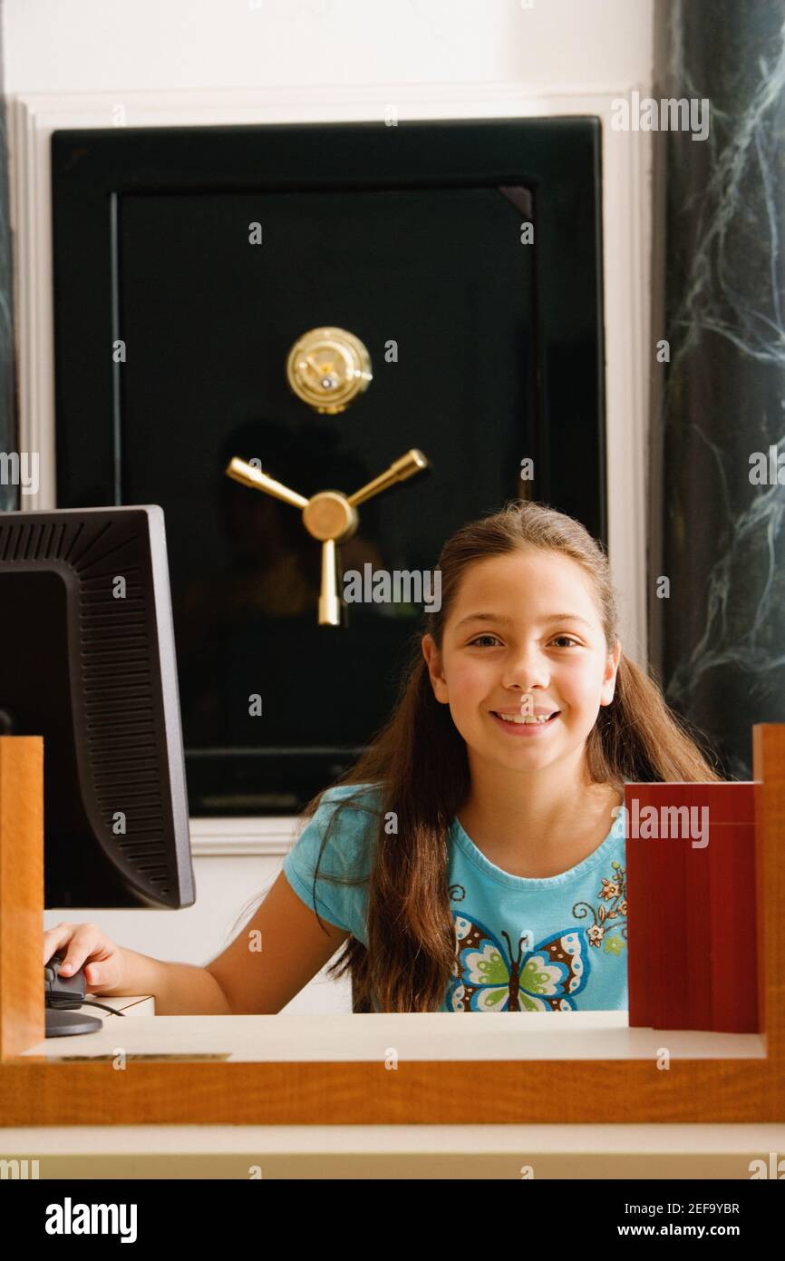 Portrait of a girl sitting in front of a safe Stock Photo - Alamy