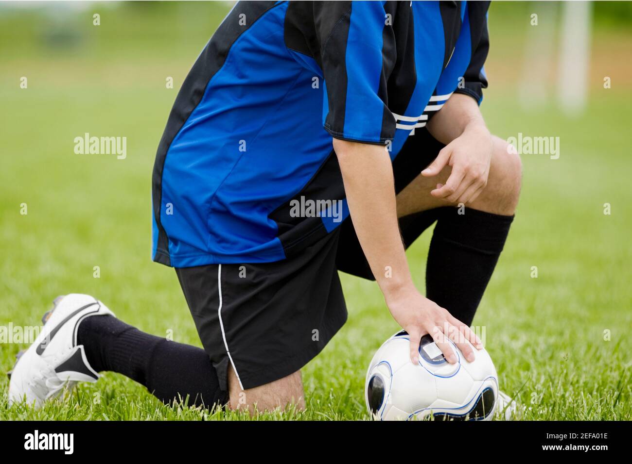 Close-up of a soccer player touching a soccer ball Stock Photo - Alamy