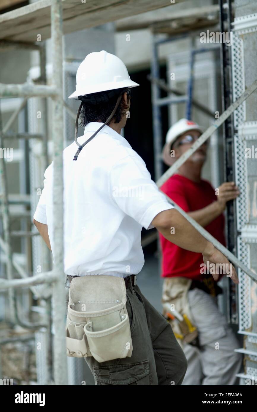 Side profile of a male architect working at a construction site with ...