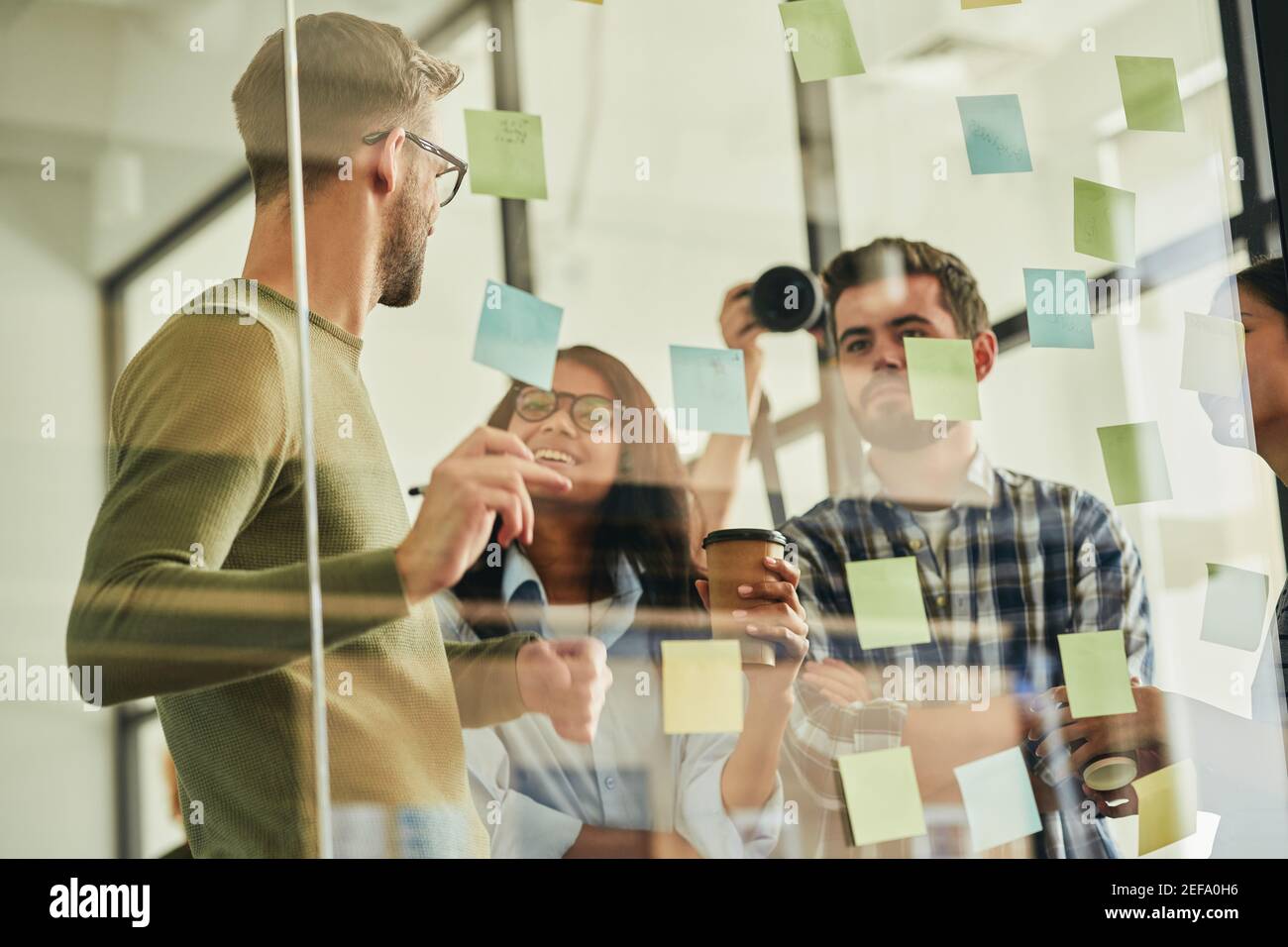 Group leader having a team discussion with co-workers Stock Photo - Alamy