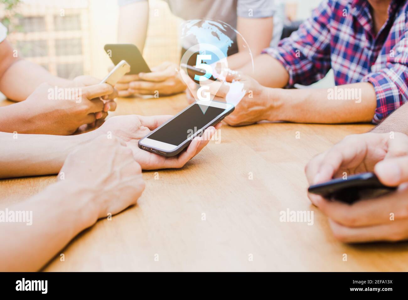 5g internet and technology concept, group of people holding phone on ...