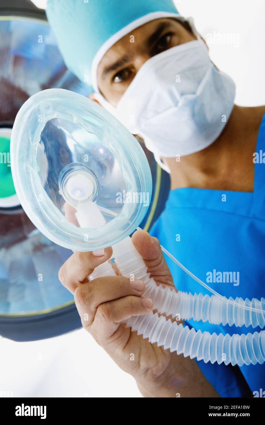 Portrait of a male surgeon holding an oxygen mask Stock Photo - Alamy