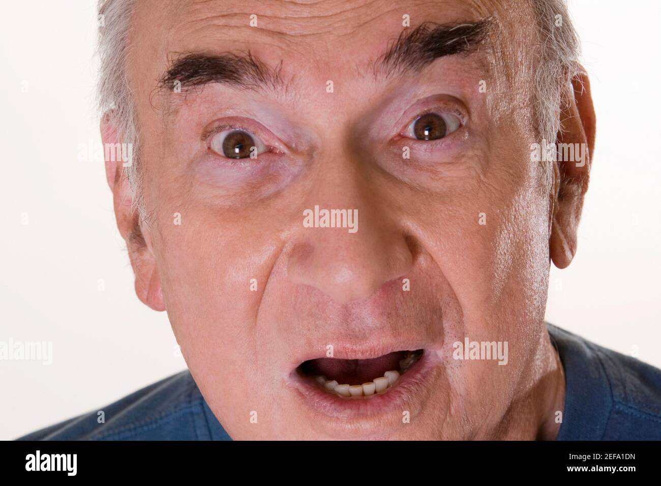 Portrait of a senior man looking shocked Stock Photo - Alamy