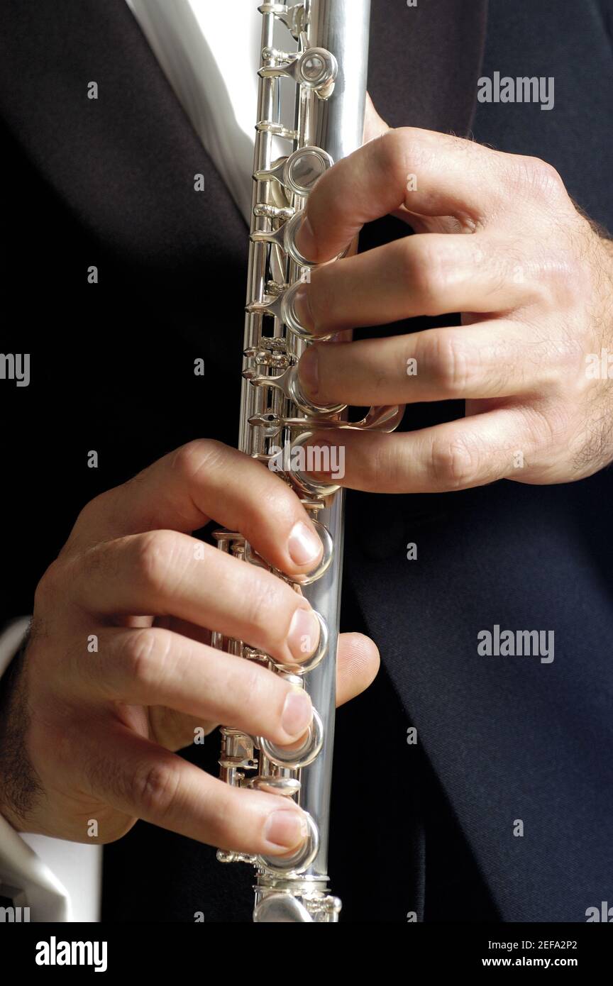 Mid section view of a musician playing the flute Stock Photo - Alamy