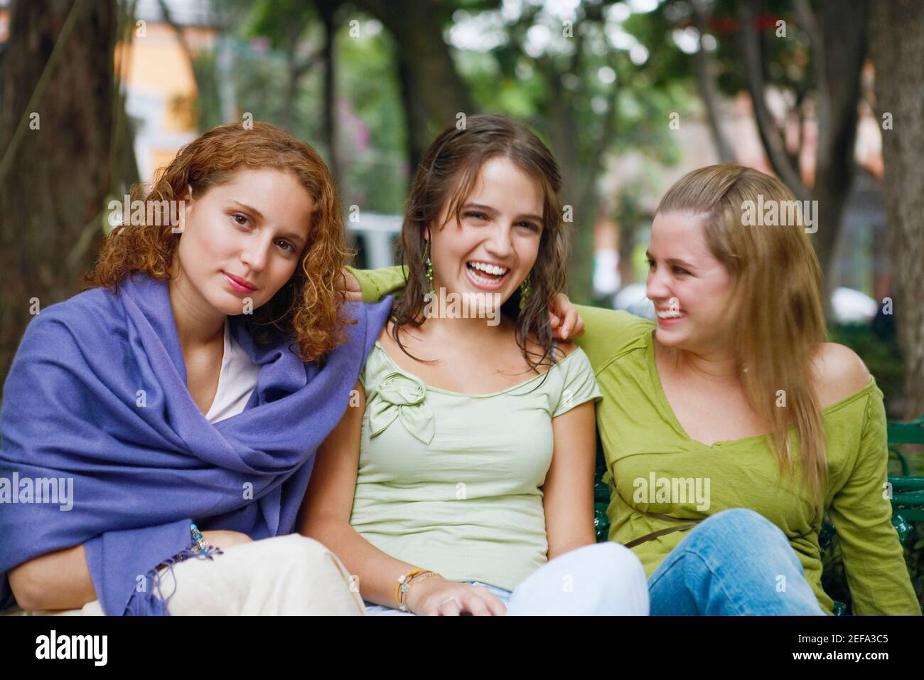 Close-up of three young women sitting together Stock Photo - Alamy