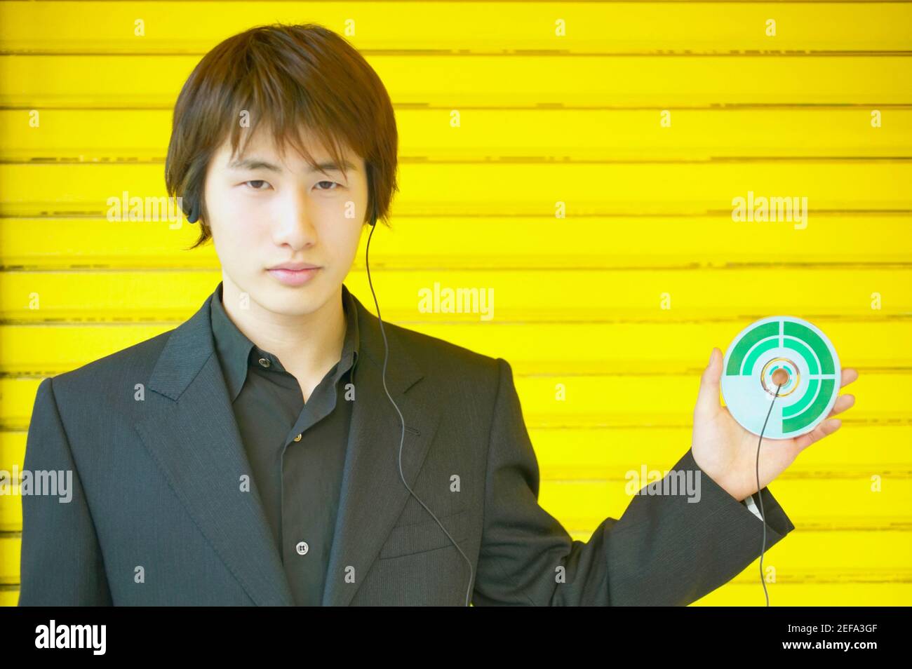 Portrait of a young man holding a CD Stock Photo - Alamy