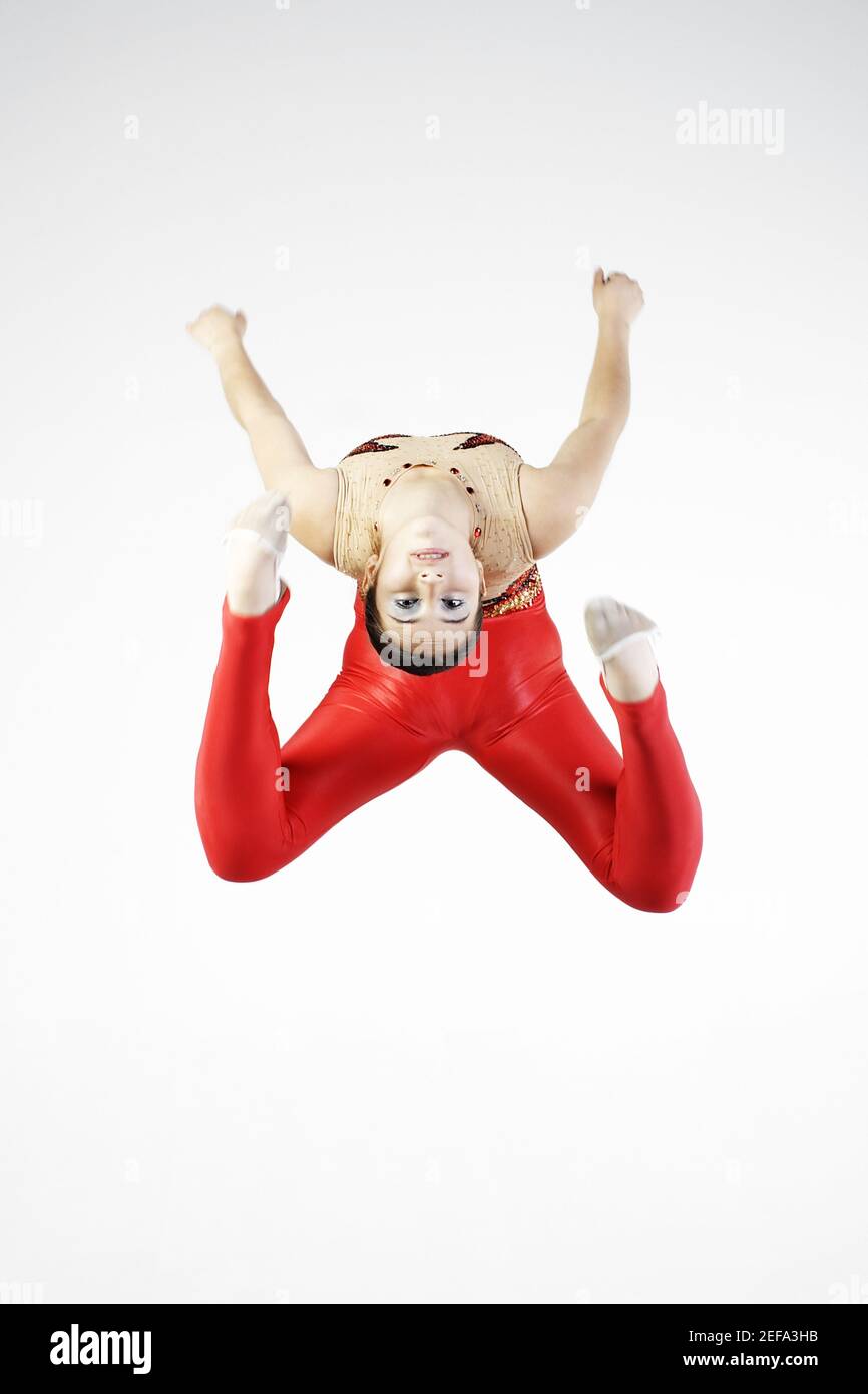 Portrait of a female gymnast jumping Stock Photo - Alamy
