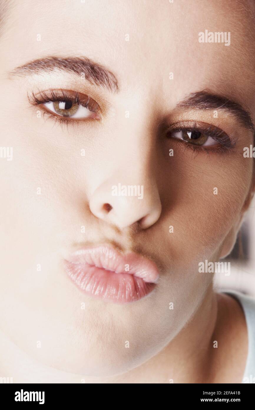 Portrait of a young woman puckering her lips Stock Photo - Alamy