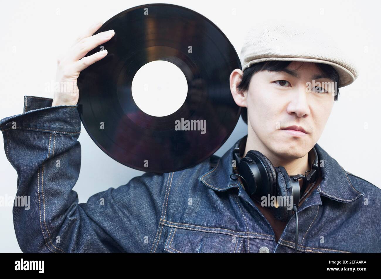 Portrait of a mid adult man holding a record on his shoulder Stock ...