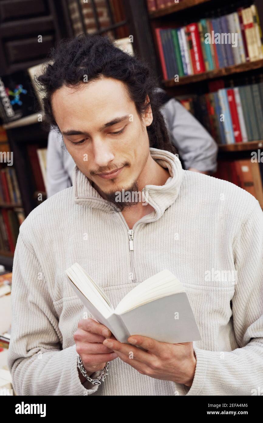 Standing holding book looking down reading education hi-res stock ...