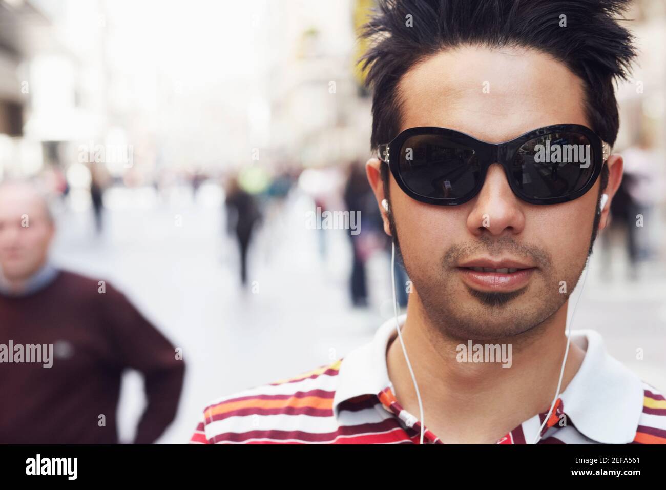 Portrait of a young man listening to an MP3 Player Stock Photo - Alamy