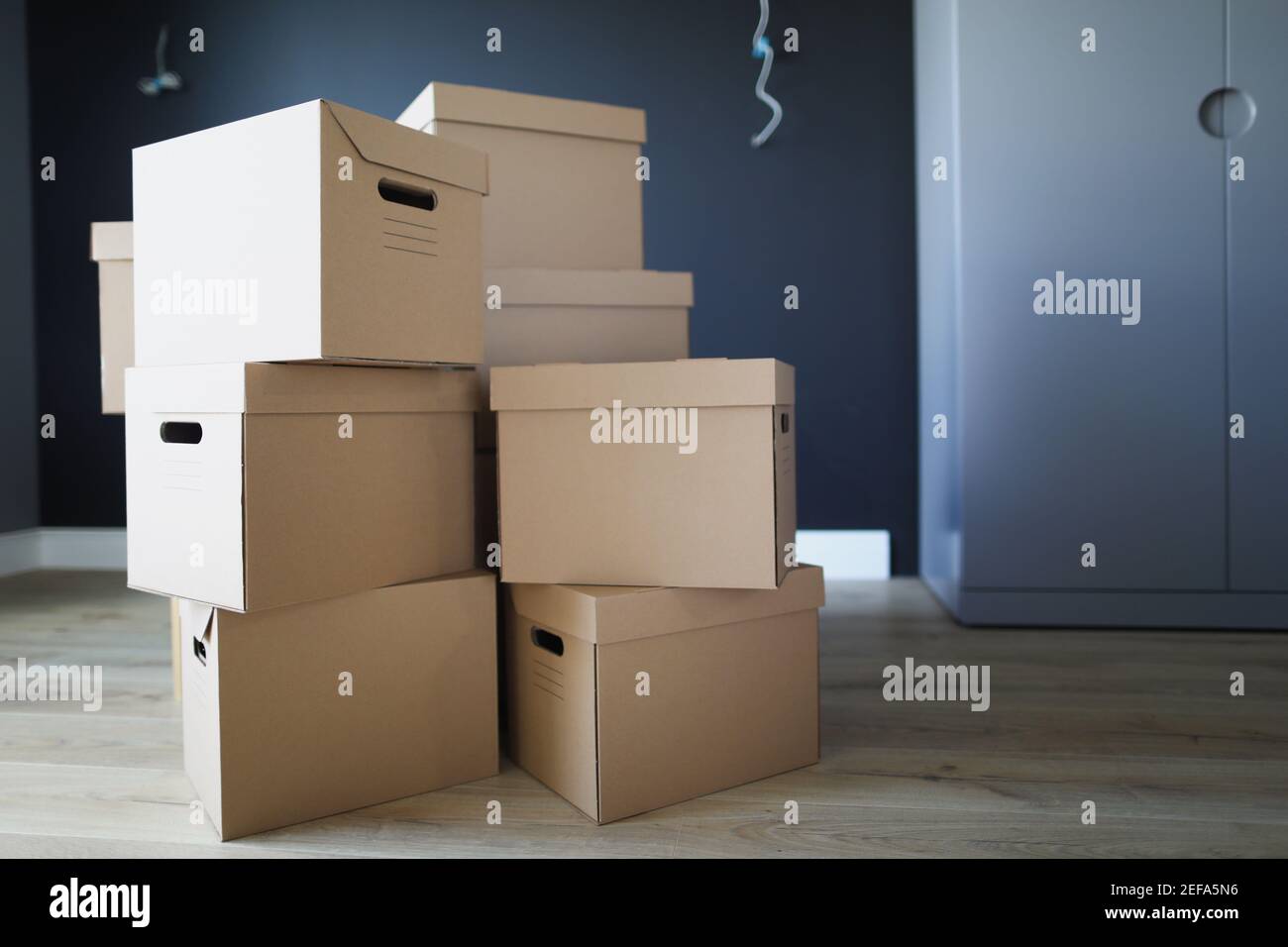 Inside room cardboard boxes on top of each other Stock Photo - Alamy