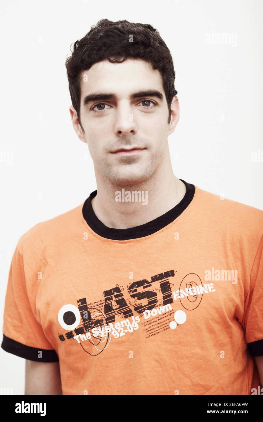 Portrait of a young man smirking Stock Photo - Alamy