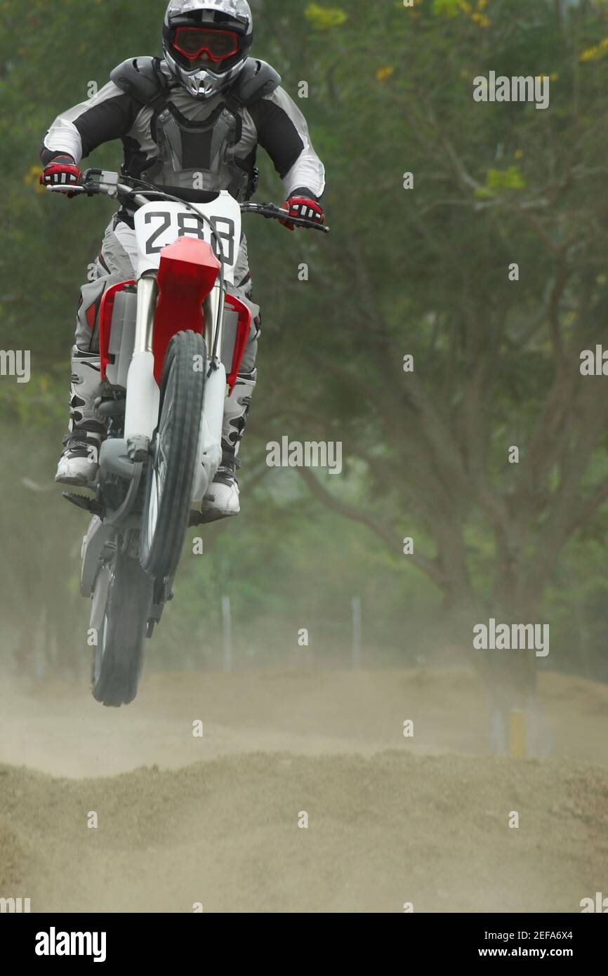Motocross rider performing a jump on a motorcycle Stock Photo - Alamy