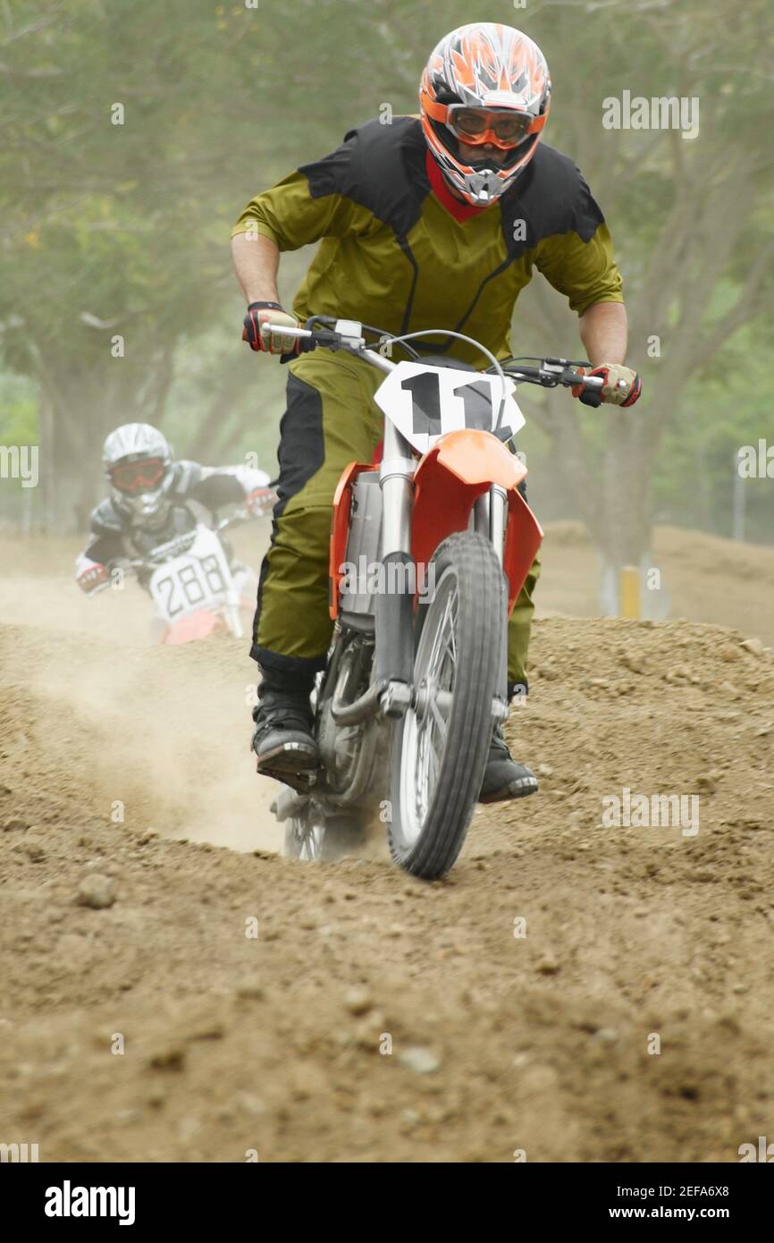 Motocross riders riding motorcycles Stock Photo - Alamy