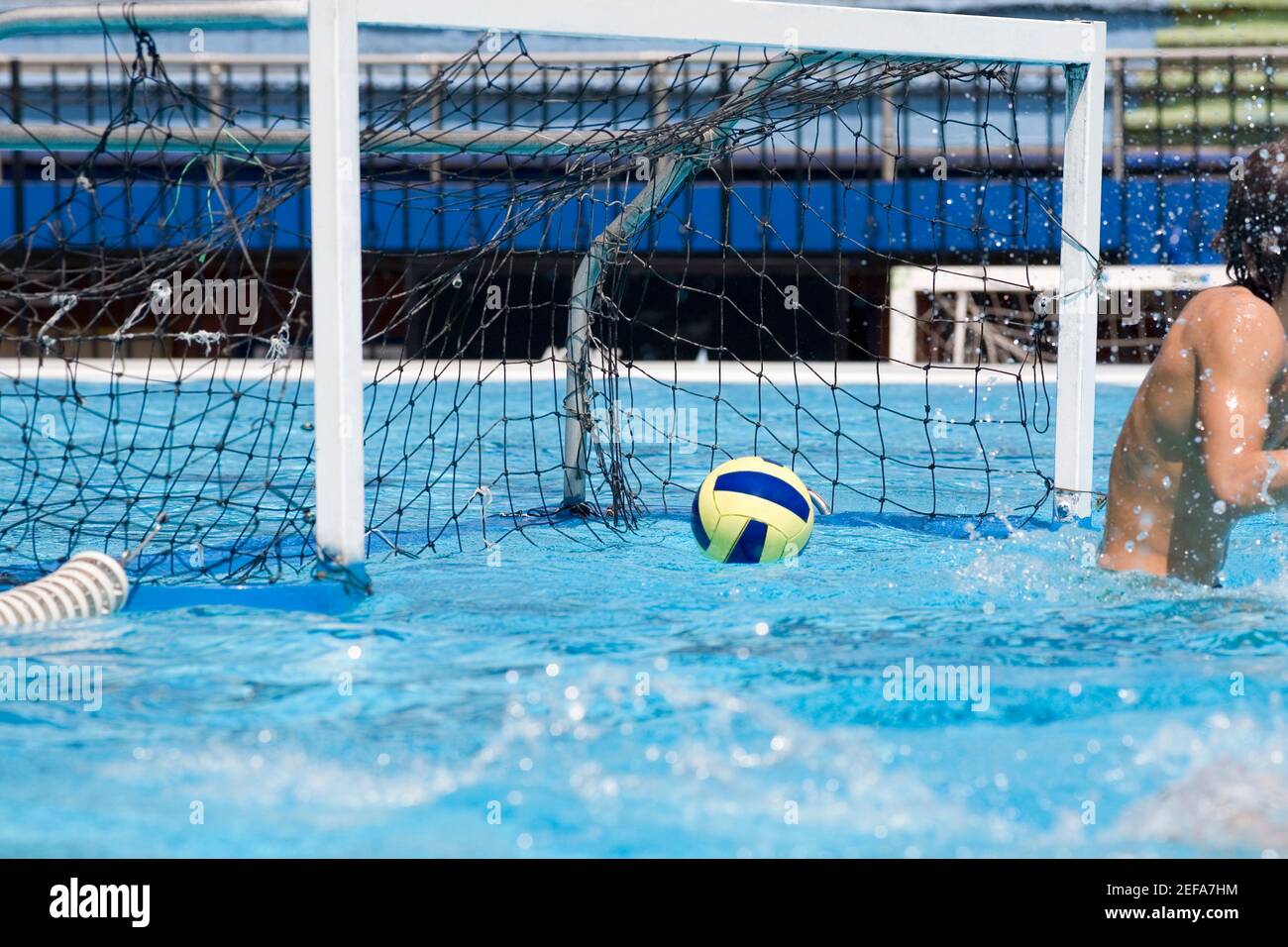 Water polo player in front of a goal post in a swimming pool Stock ...