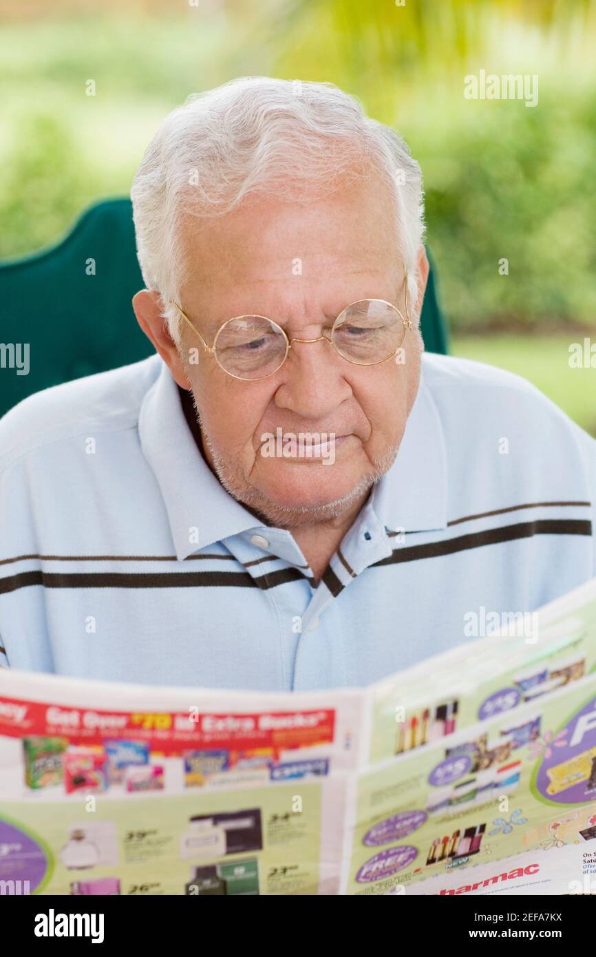 Senior man reading a newspaper Stock Photo - Alamy