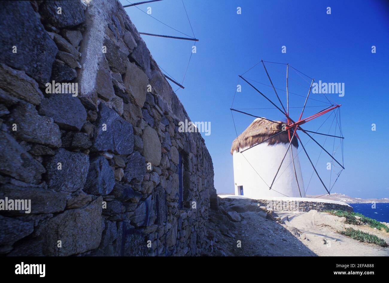 Traditional windmill on the beach Stock Photo - Alamy